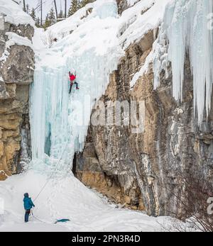 Rowan Lovell and Brandon Prince climbing in Johnston Canyon Stock Photo ...