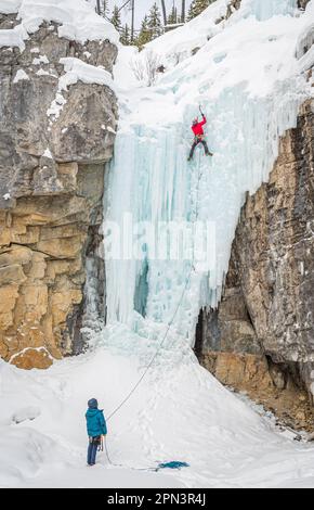 Rowan Lovell and Brandon Prince climbing in Johnston Canyon Stock Photo ...