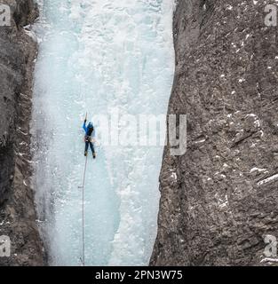 Rowan Lovell climbing a route called Wicked Wanda WI4+ in Canada Stock ...