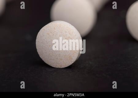 Open and unpacked tablets close-up, a large number of identical medical ...