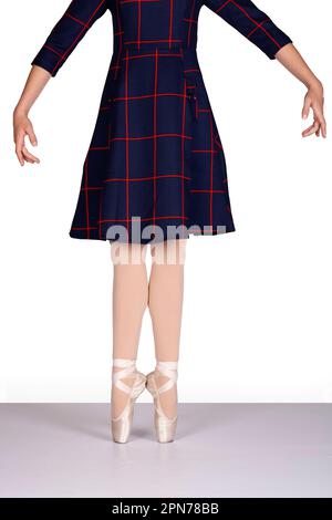 En Pointe heels together hands bras bas looking down full length ...