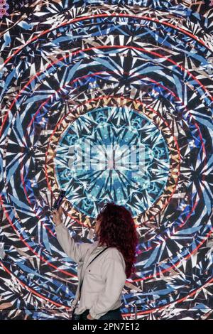 A person takes a photo of The Spaces In-Between installation by visual ...