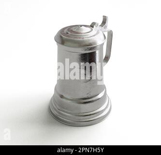 A vintage silver drinking tankard with a lid on an isolated white ...
