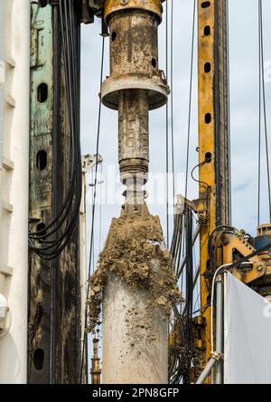 Dirt falling from auger or drill creating foundations for new ...