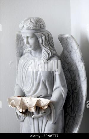 Church of Saints Peter and Paul. Angel with holy water font in hands ...