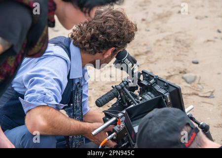Film crew on coastal location using RED camera Stock Photo - Alamy