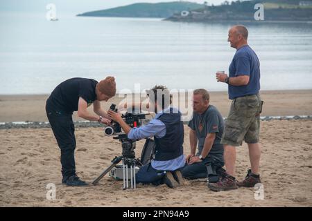 Film crew on coastal location using RED camera Stock Photo - Alamy