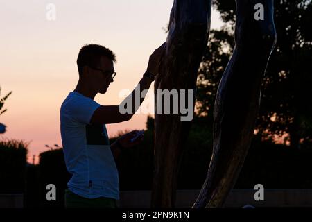 People venerating the statue of the Risen Christ in Medjugorje. The ...