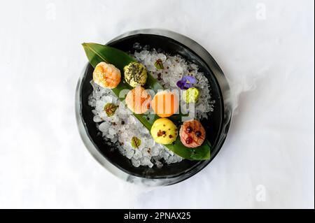 Temari sushi on a black plate with ice Stock Photo - Alamy