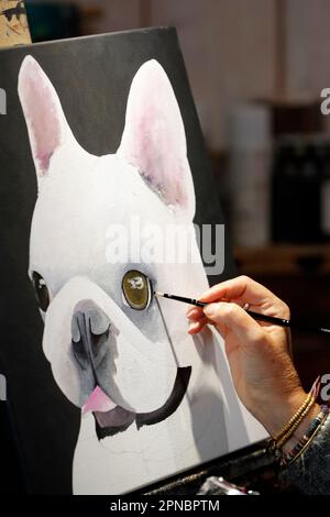 French artist Muriel Mollier Pierret painting in her gallery. Saint ...