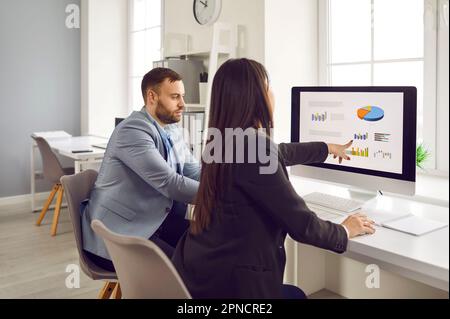 Two Businesspeople Analyzing Graph On Laptop Stock Photo - Alamy