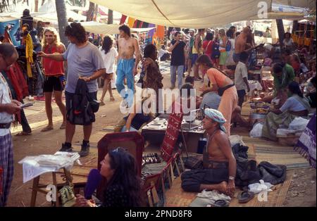 Shops and Tourists at the old style Anjuna Flea market on the Coast at ...