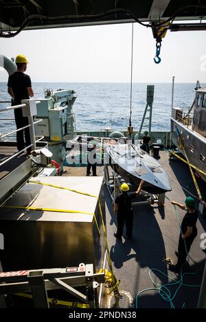 Royal Canadian Navy sailors crane a Meggitt Hammerhead drone into the ...