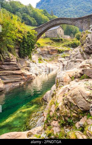 Ancient double arch stone Roman bridge (Ponte dei Salti) over the clear ...