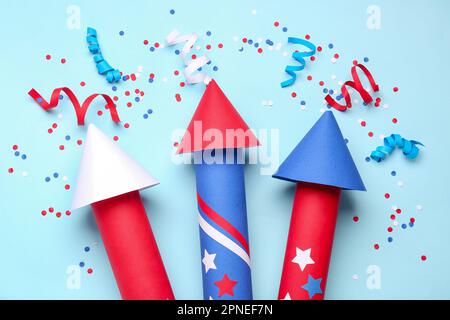 Firework rockets, confetti and serpentine for Independence Day on pink ...