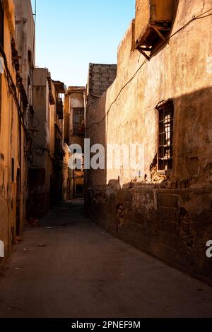 A very narrow alley in downtown with arabic inscriptions, Lahore ...