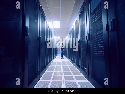 Female technician working in server room Stock Photo - Alamy