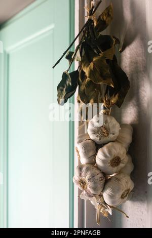 garlic hanging up to dry Stock Photo - Alamy