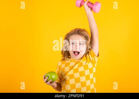 Cute child boy pumping up arm muscles with dumbbell. Fitness kids with dumbbells. Kids sport ...