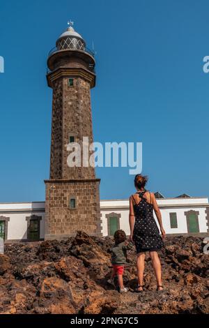 Mother and son visiting the beautiful Orchilla lighthouse on El Hierro ...