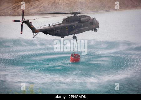 Bundeswehr helicopter with fire extinguishing tank 5000 litres, during ...