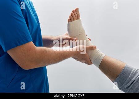wrapping the sprained foot Stock Photo - Alamy
