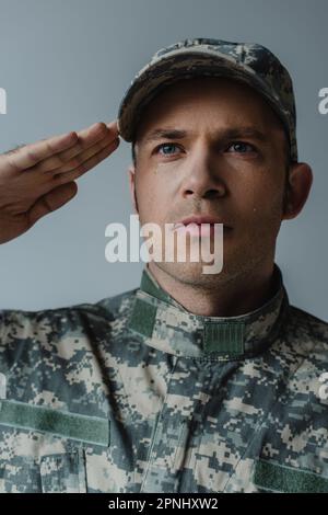 sad military man crying while saluting during memorial day isolated on ...