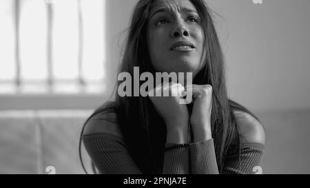 Depressed young woman agonizing over grief and despair in monochromatic ...