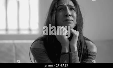 Depressed young woman agonizing over grief and despair in monochromatic ...