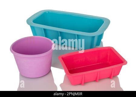 Three silicone molds for baking, macro, isolated on white background ...