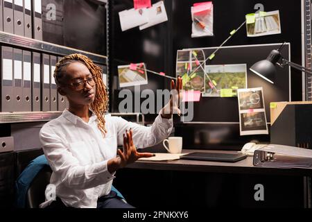 Law enforcement investigator using ar technology to analyze crime scene ...