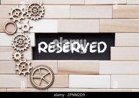 Yellow note paper with word reserved on cork board background with copy ...