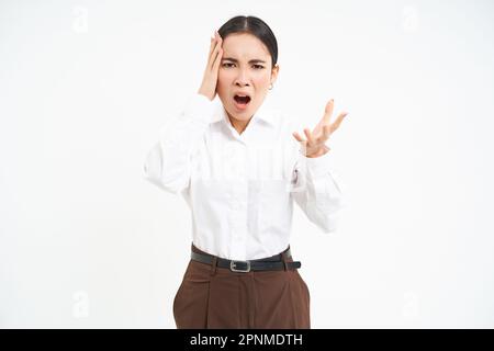 Angry asian woman yells and shakes fists, shouts at employees, stands ...