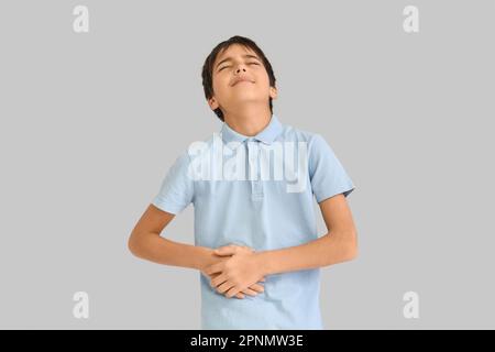 Little boy with appendicitis on grey background Stock Photo - Alamy