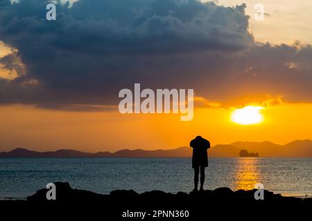 Siluate lonely man at the beach before sunset background Stock Photo ...