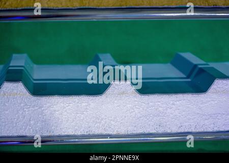 Foam insulation under a tin roof Stock Photo - Alamy