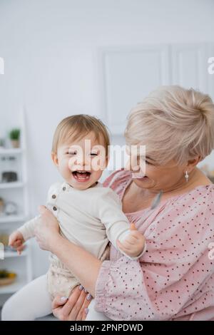 Happy overjoyed toddler girl kid in wireless headphones relaxing ...