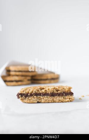 cookies packed in white parchment bags, chocolate filled oat cookies in ...