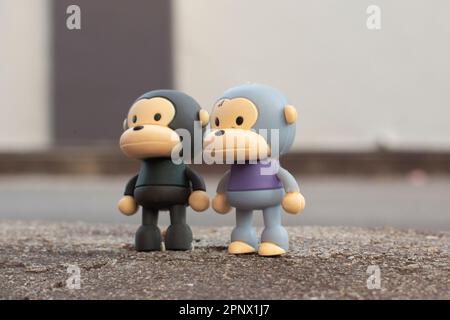 infrared image of the monkey toys on the asphalt street Stock Photo - Alamy