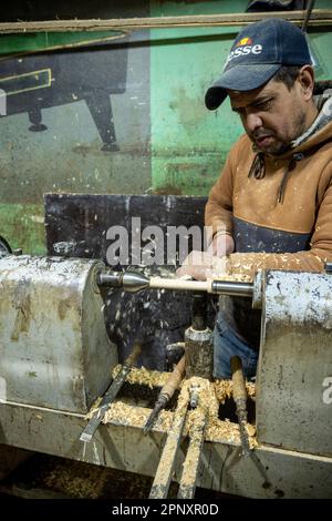 Craftsman manufacturing wooden parts on a lathe Stock Photo - Alamy
