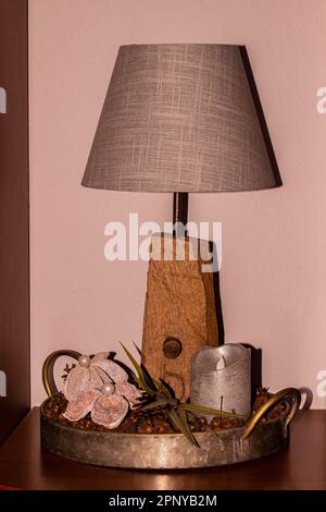 Stylish lamp on wooden table in bedroom Stock Photo - Alamy