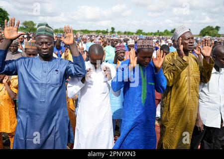 Nigerian Muslims pray in an open ground field during the Eid al-Fitr ...