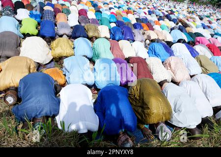 Nigerian Muslims pray in an open ground field during the Eid al-Fitr ...