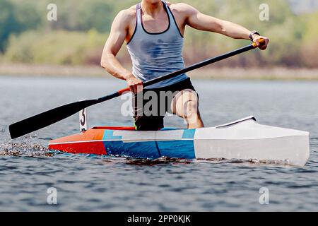 front view male athlete canoeist on canoe single, after finish line ...