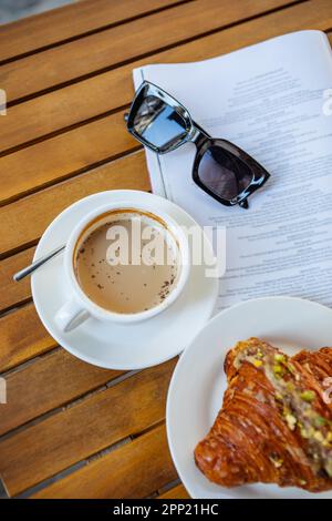 Breakfast time with croissant, coffee, and magazine Stock Photo - Alamy