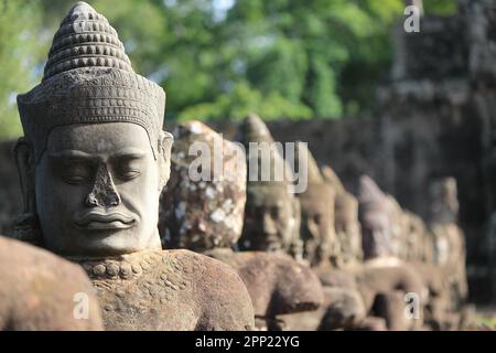 An antique statue standing majestically in the Angkor Wat temple ...
