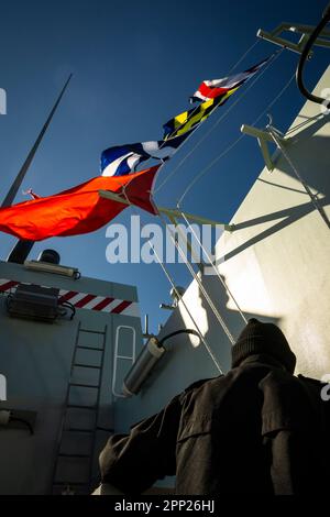 Sailor raising a hoist of signal flags onboard HMCS Margaret Brooke ...