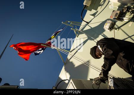 Sailor raising a hoist of signal flags onboard HMCS Margaret Brooke ...