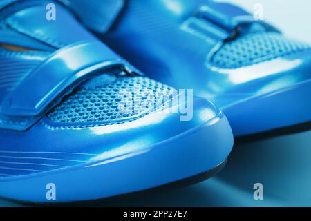 Blue Shiny Bicycle Shoes for Road Bike on Blue Background Stock Photo ...