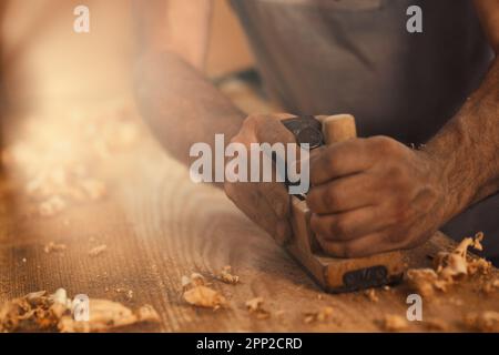 The wood artisan, a robust and strong man known as a carpenter, hand ...
